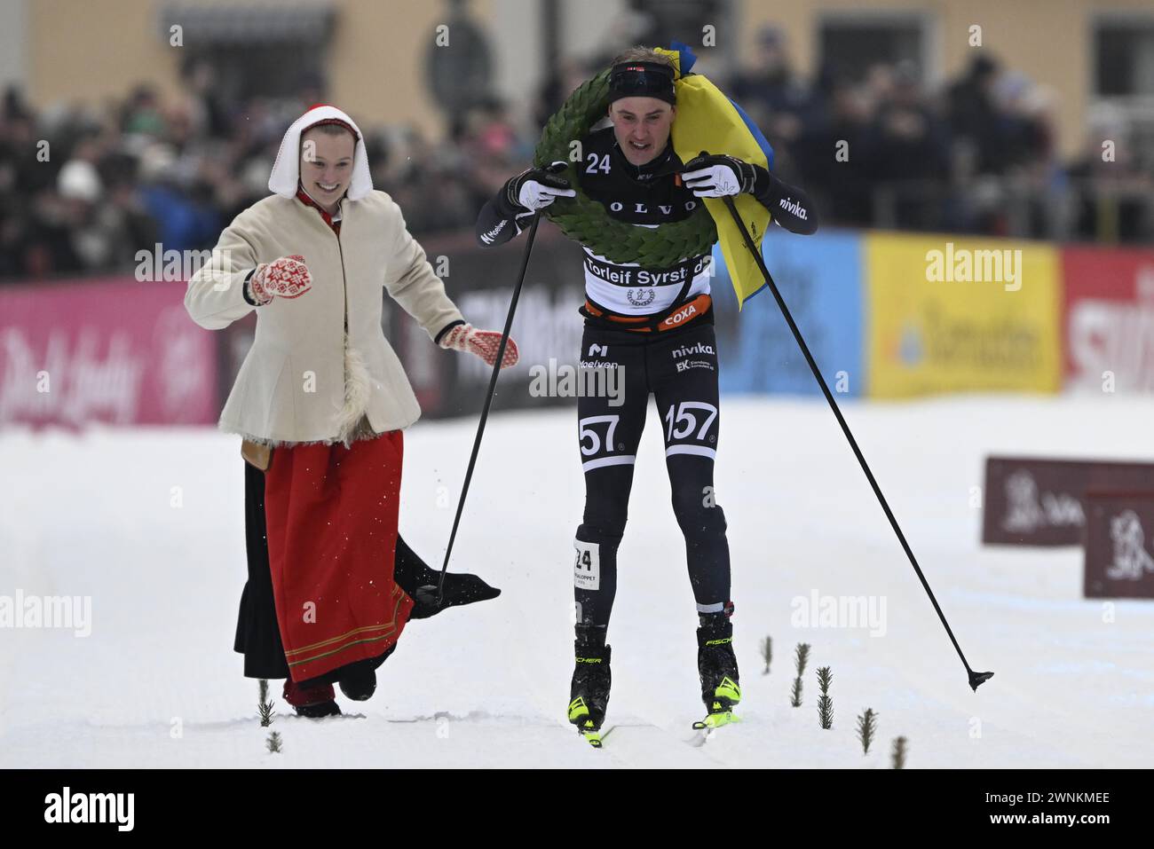 Torleif Syrstad, Norway, crosses the finish line and receives the ...