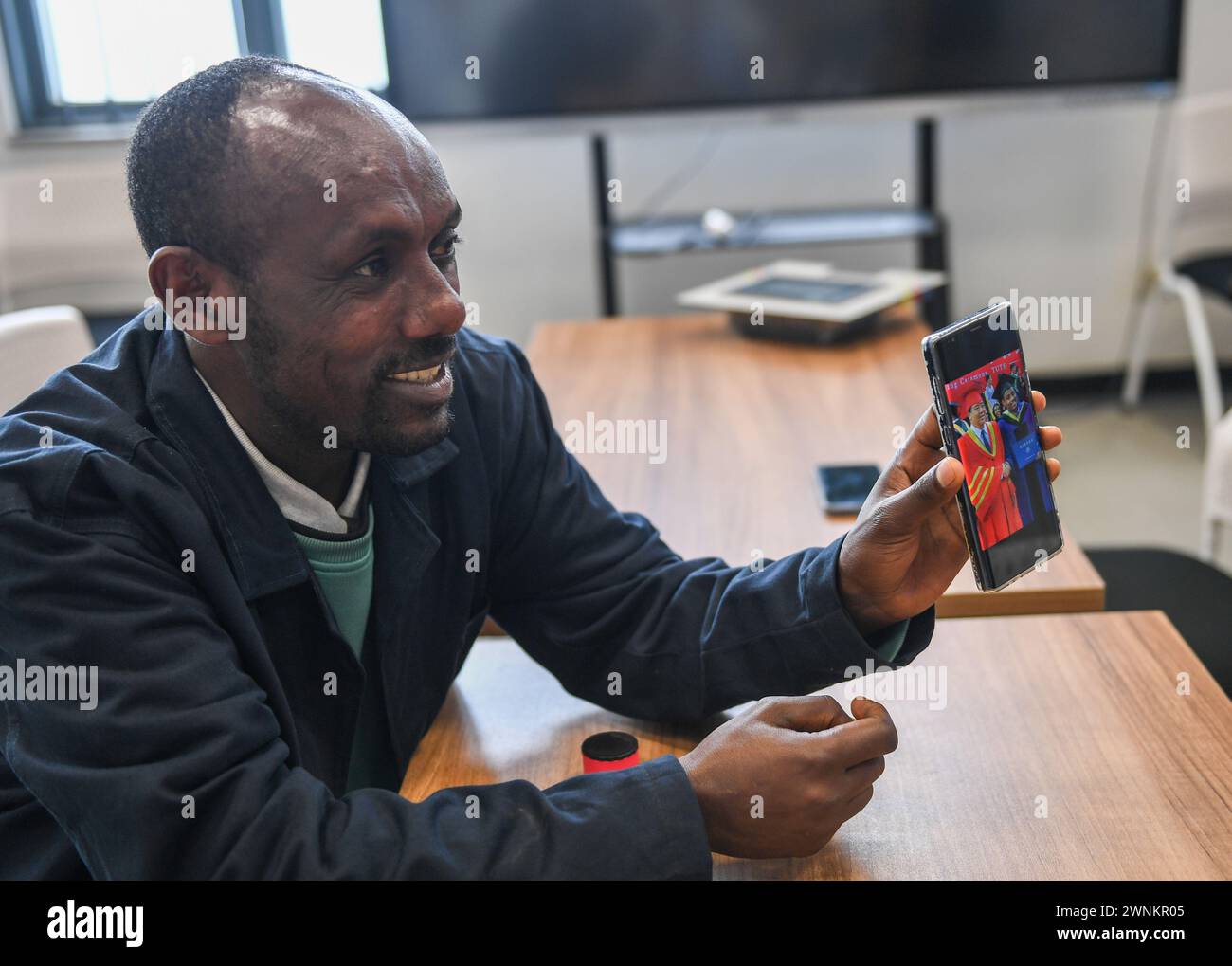 Addis Ababa, Ethiopia. 15th Feb, 2024. Yonas Akele shows a photo of him ...