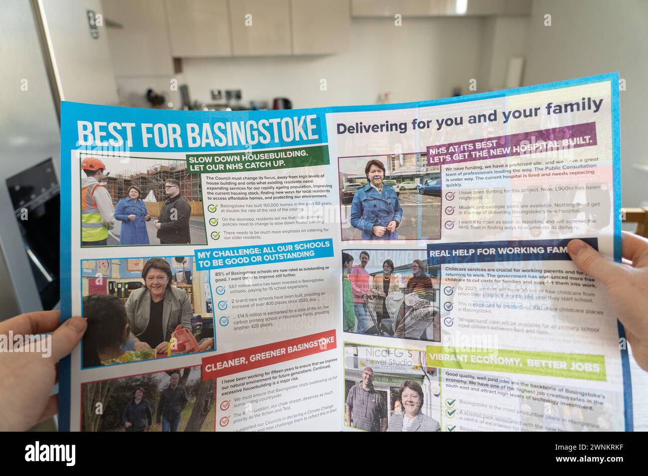 A UK man / voter holding and reading a Conservative May 2024 local ...