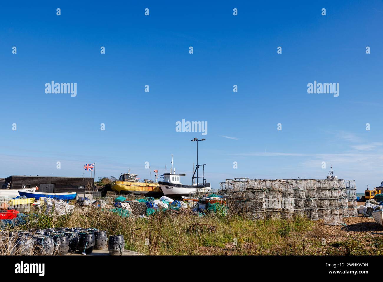 Beached traditional small wooden fishing boats and lobster pots on the ...