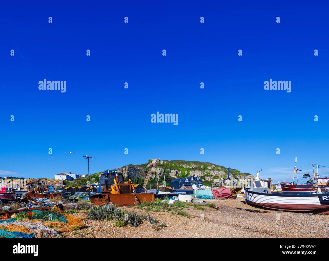 Rusty bulldozer tractor and beached traditional small wooden fishing ...