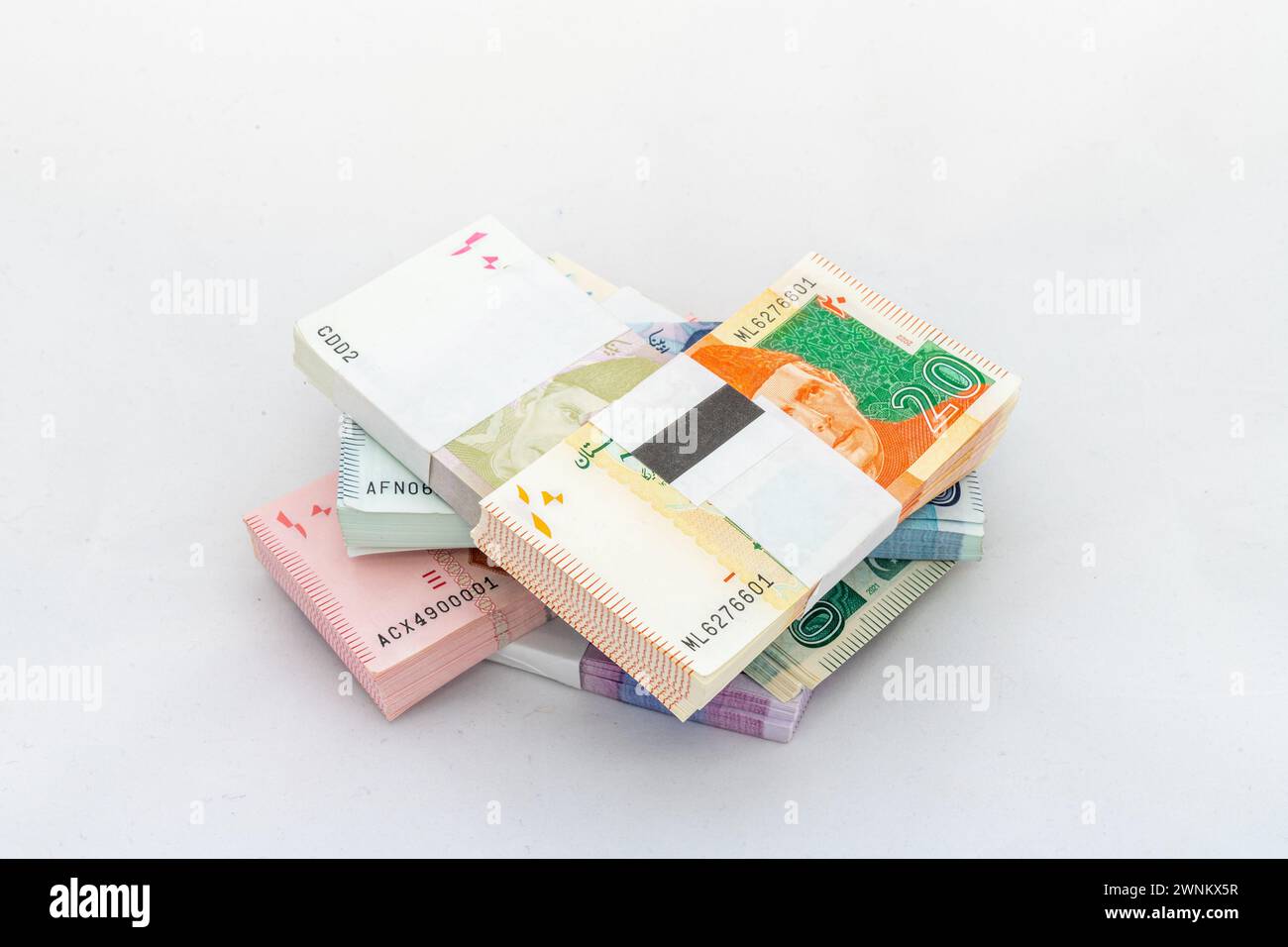 Different denominations of Pakistani banknotes bundles on white ...