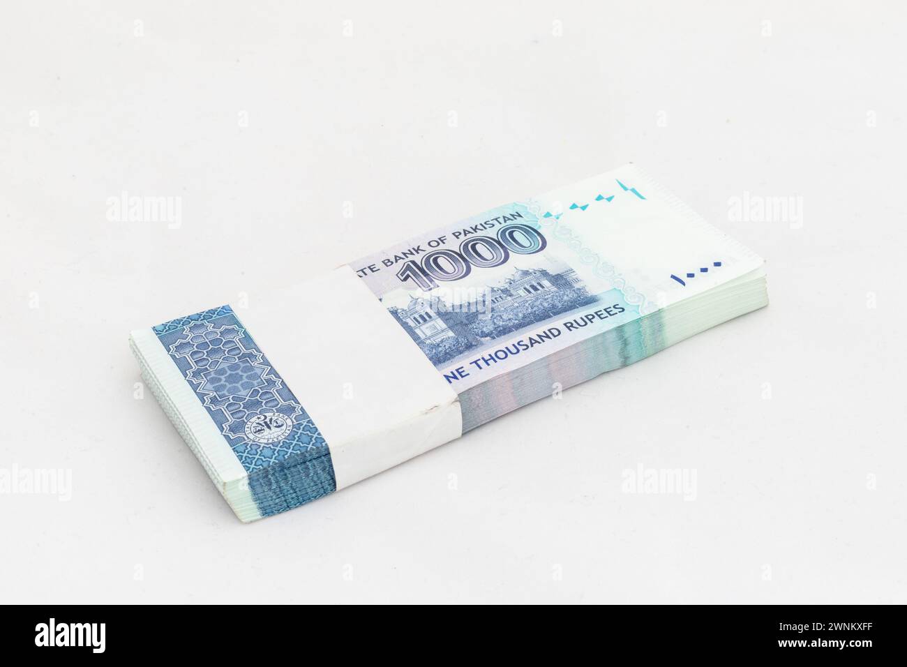 Pakistan one thousand rupees denomination note bundle on white isolated ...