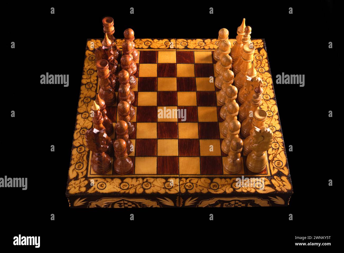 Handmade chess pieces before their debut on a black background ...