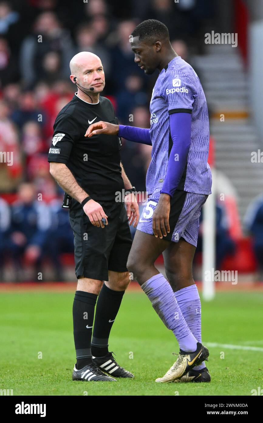 Referee Paul Tierney checks on Ibrahima Konate of Liverpool after ...