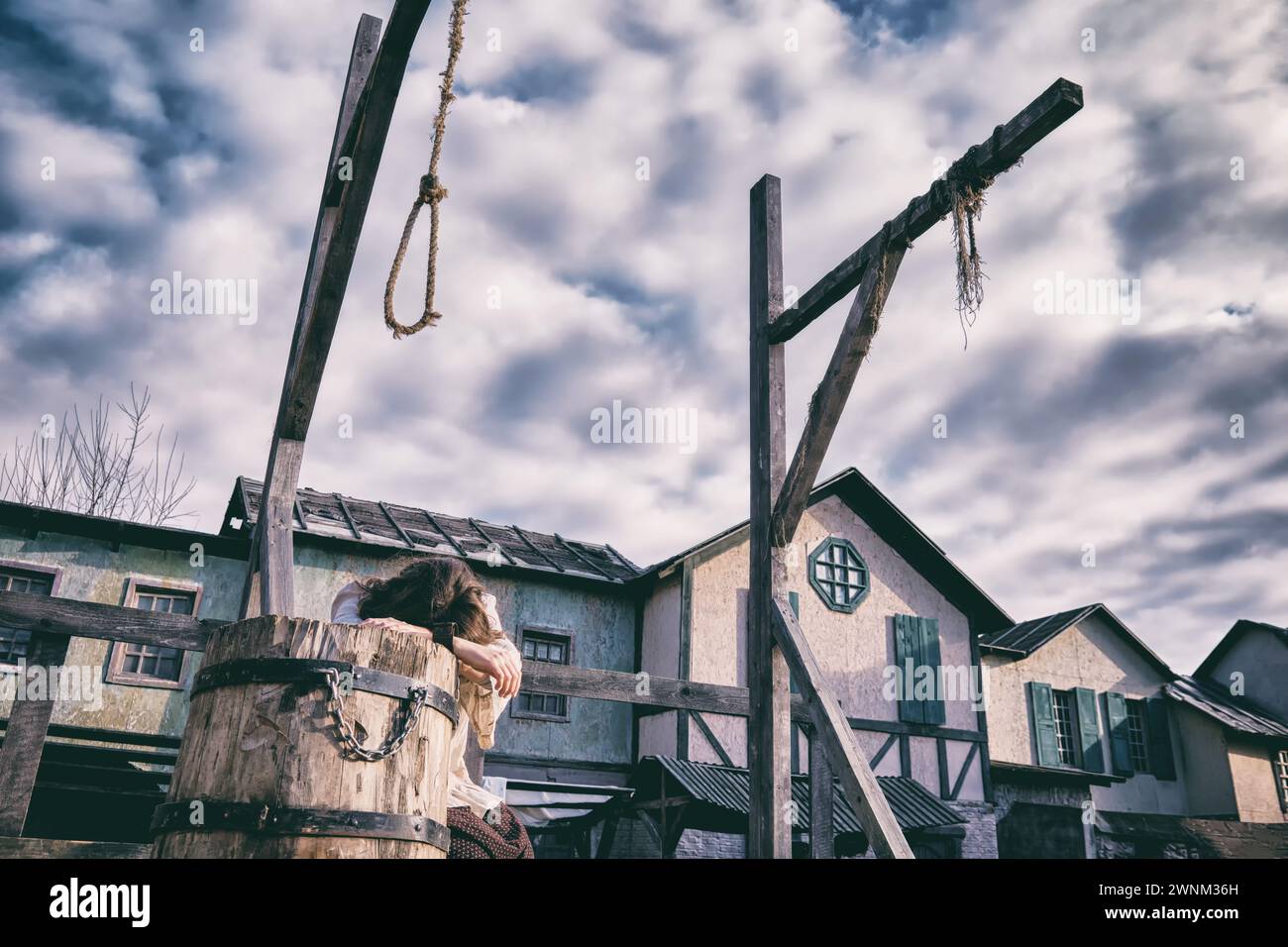A woman cries on the scaffold in the city square with a gallows for ...