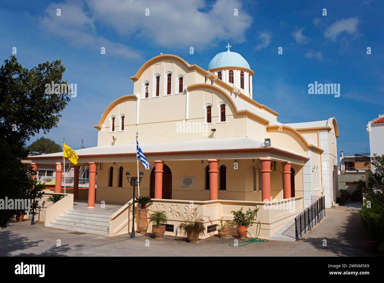 A traditional Greek church with a blue dome under a clear sky ...