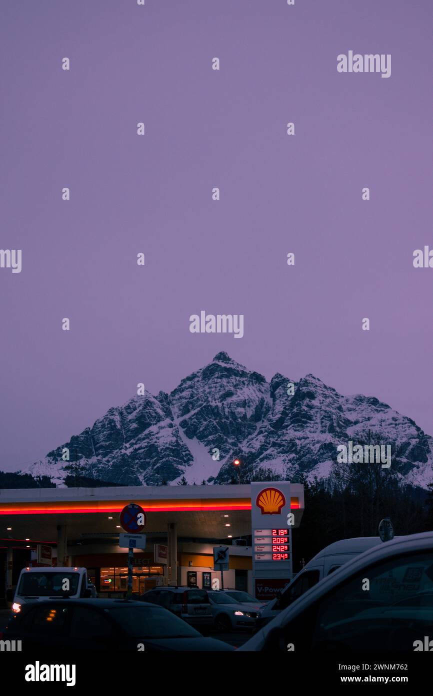 Shell petrol station in the foreground at dusk, snow-covered Serles ...