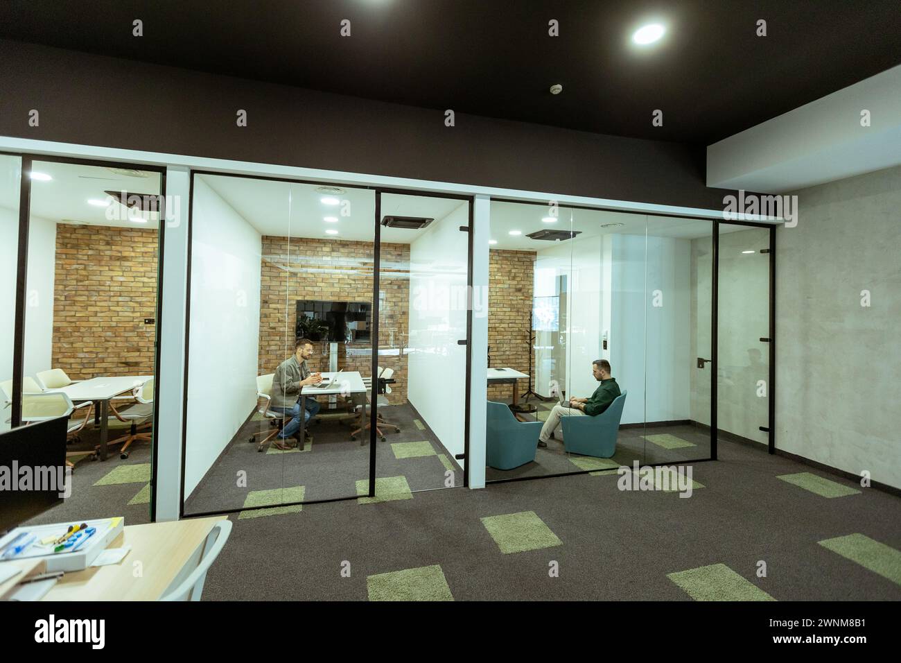 Person is immersed in a task in a stylish office with transparent glass ...