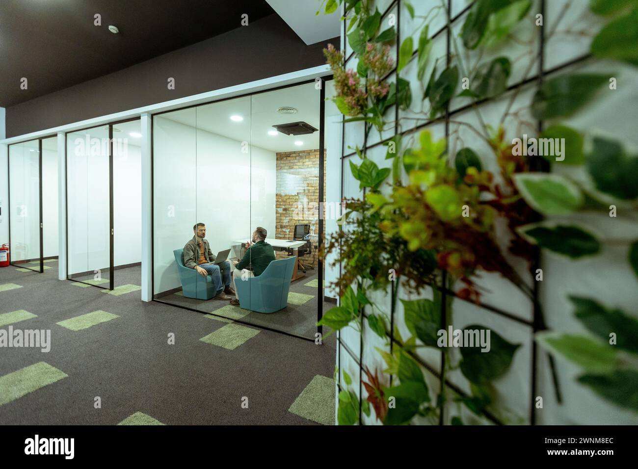 Two professionals engage in a conversation while seated comfortably in ...