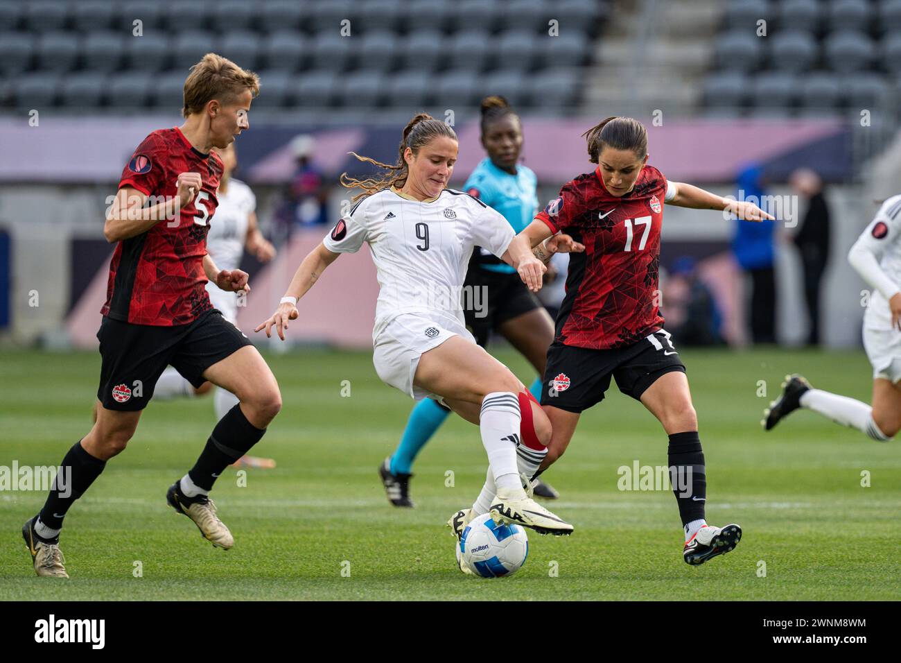Costa Rica forward María Paula Salas (9) is defended by Canada ... Costa Rica forward María Paula Salas (9) is defended by Canada ...