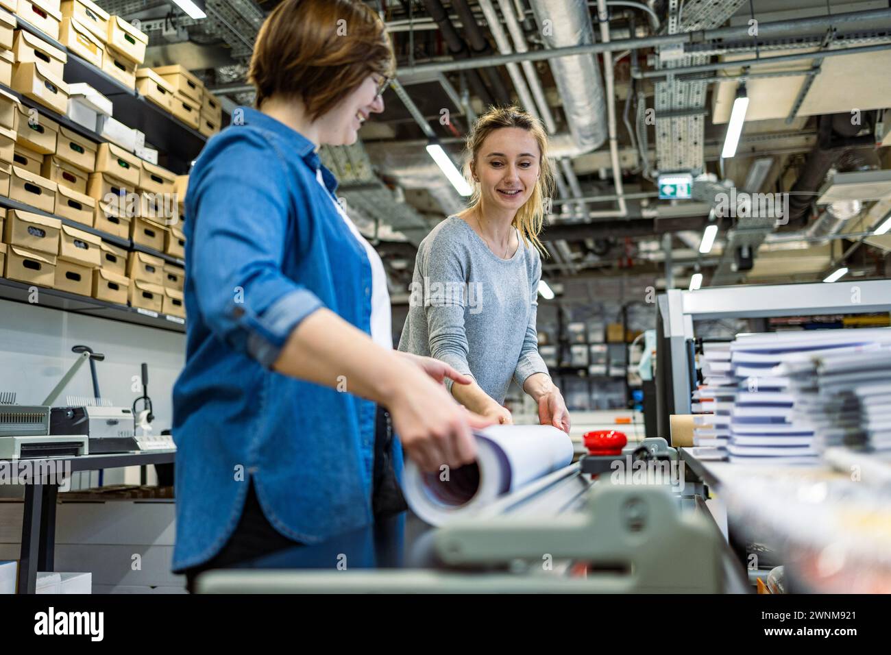 Professional female employees working in a printing house Stock Photo ...