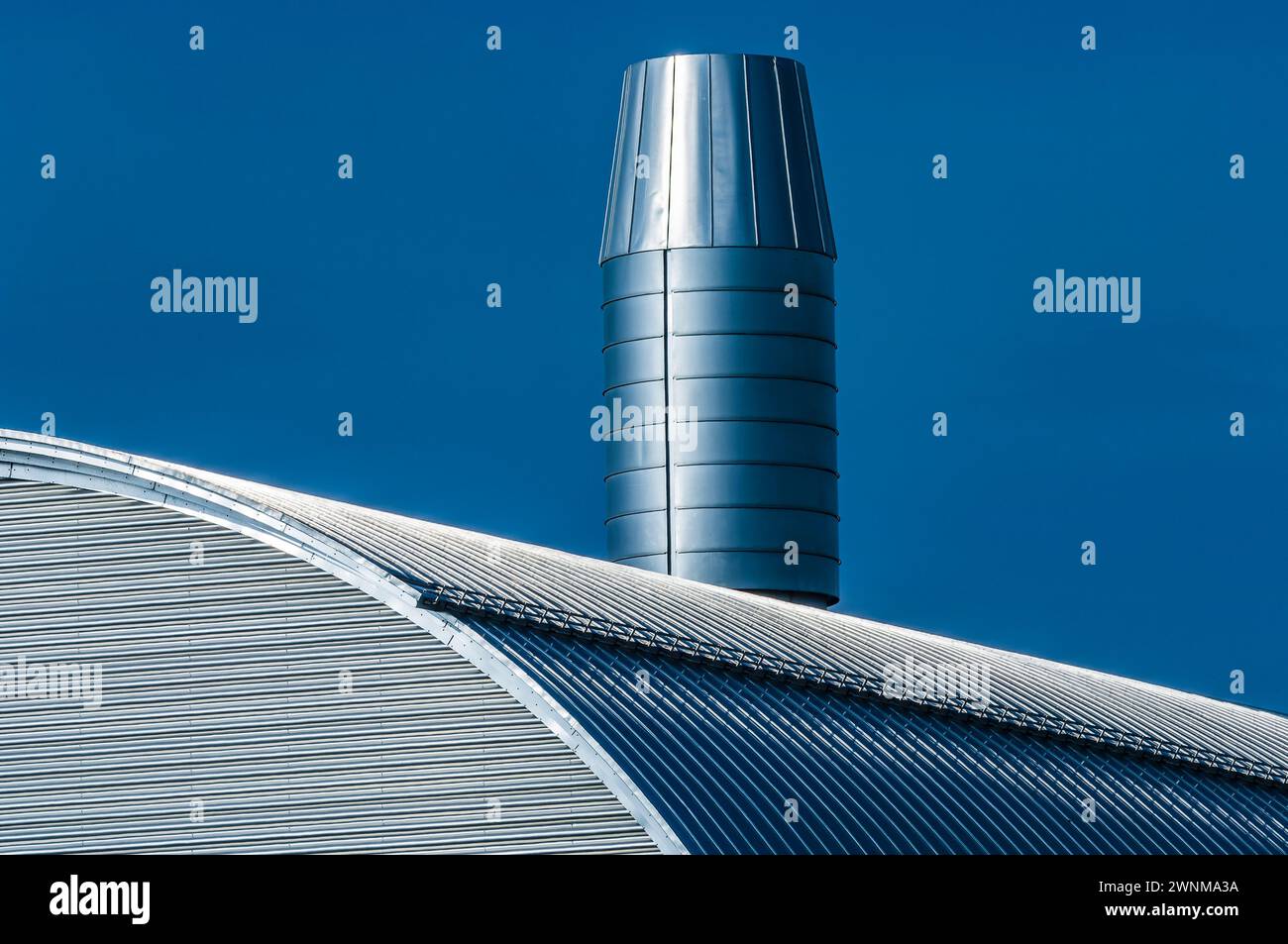 A sleek, metallic ventilation system stands prominently atop a curved ...