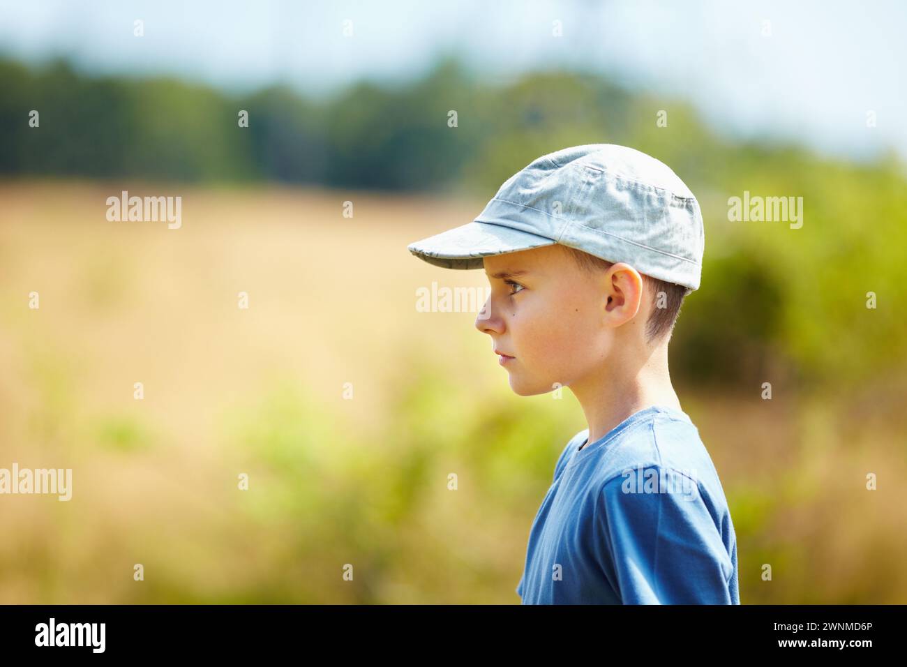 Candid profile portrait of a caucasian boy with cap outdoor Stock Photo ...