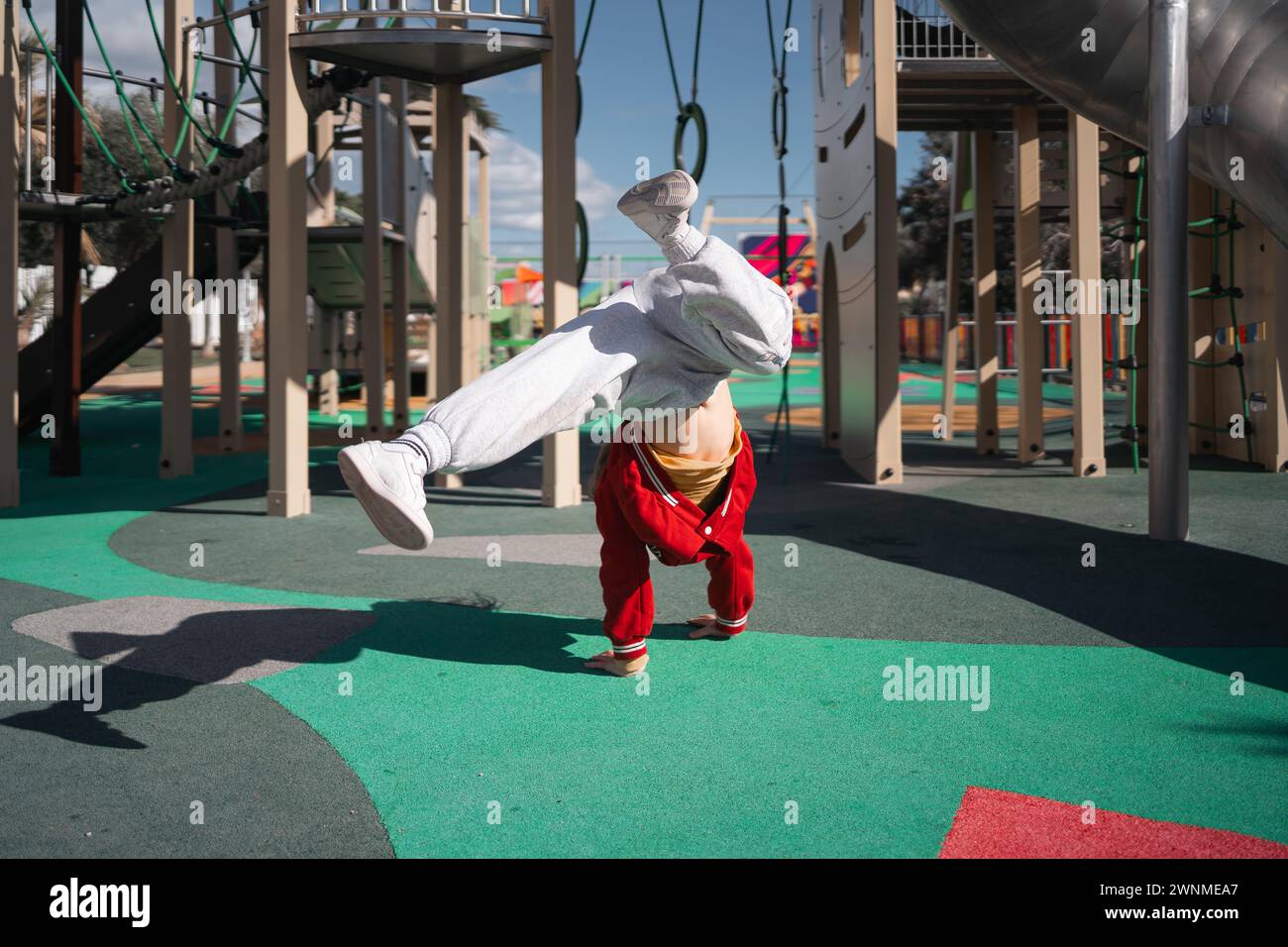 Child girl doing handstand on the outdoors playground. Funny active ...