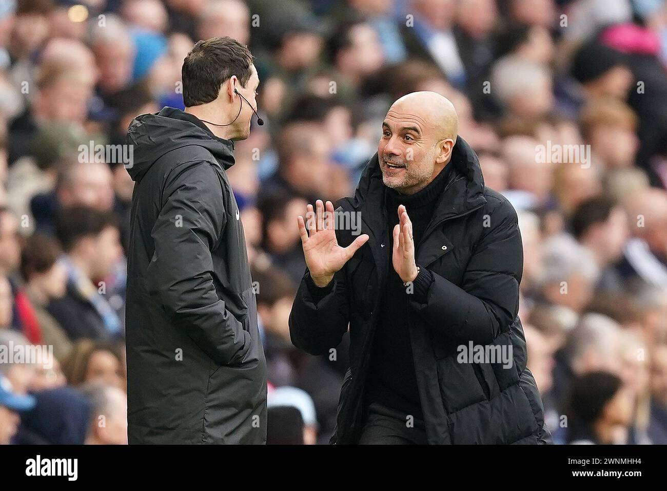Manchester City manager Pep Guardiola (right) speaks with fourth ...