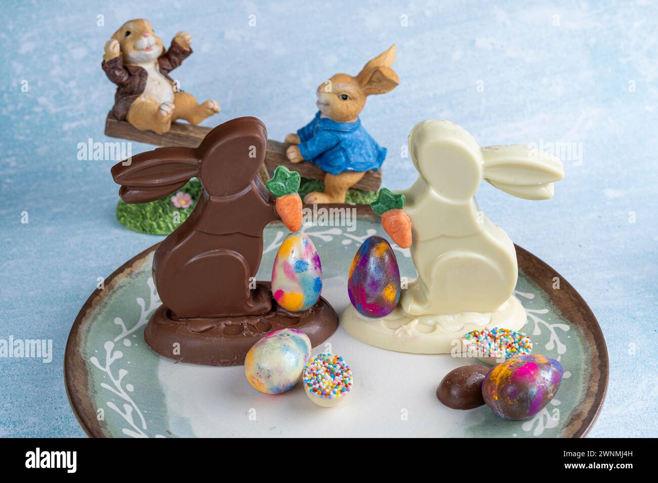 Milk and white chocolate bunnies next to small chocolate eggs 1 Stock ...