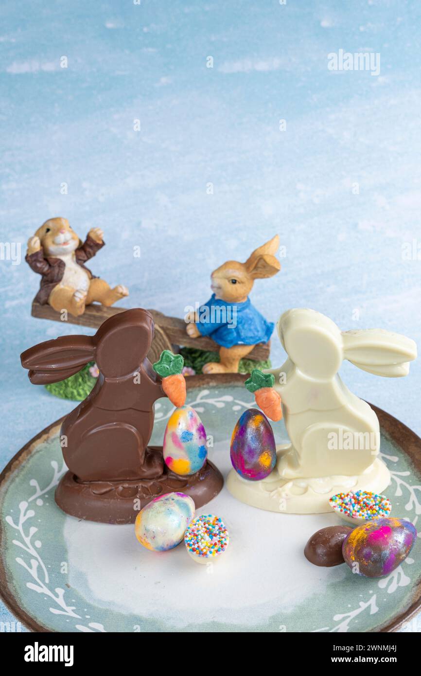 Milk and white chocolate bunnies next to small chocolate eggs 2 Stock ...