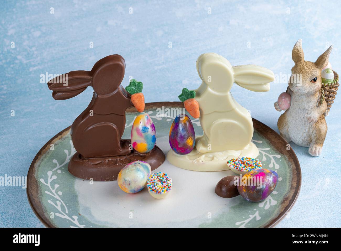 Milk and white chocolate bunnies next to small chocolate eggs 3 Stock ...