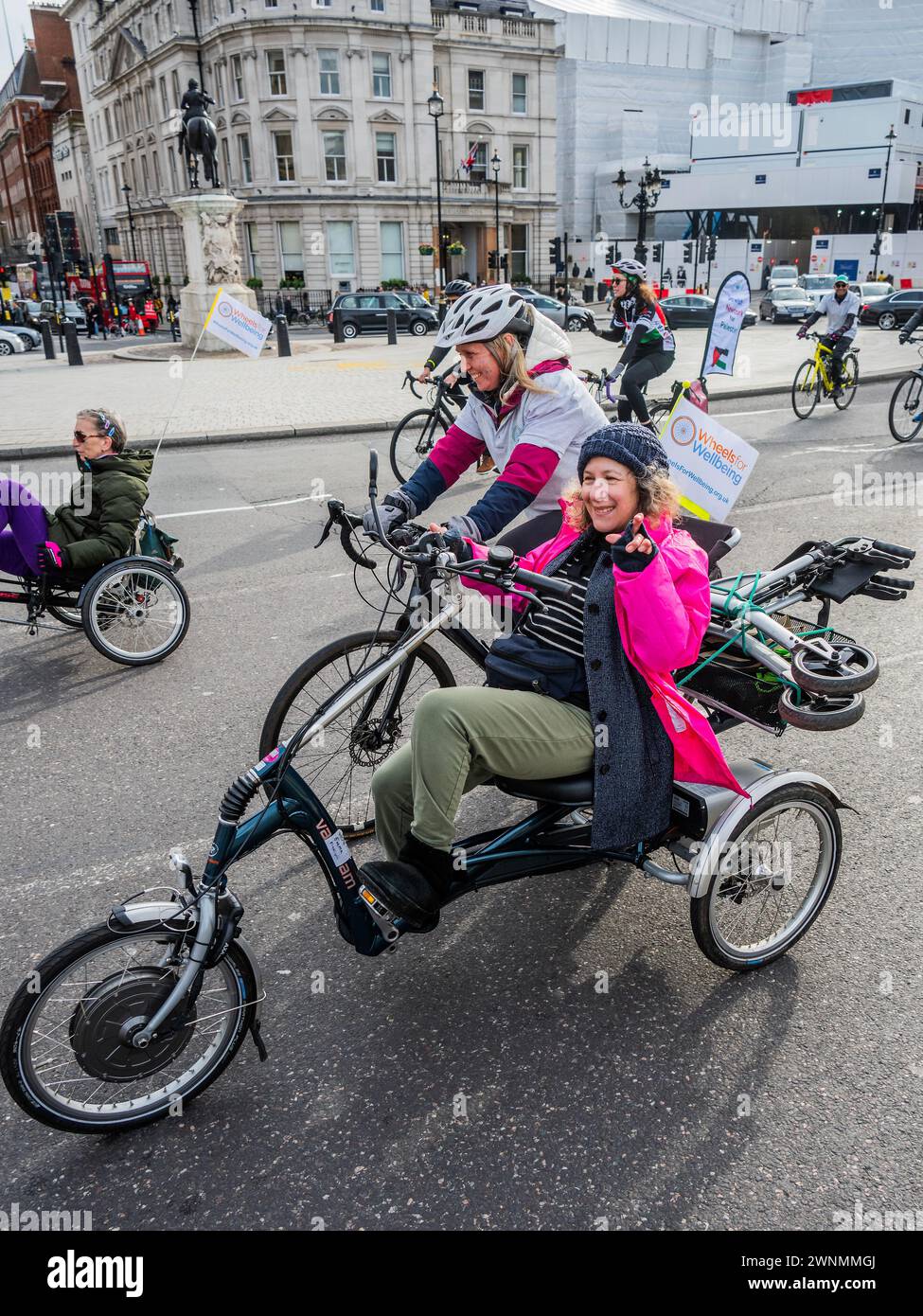 London, UK. 3rd Mar, 2024. A rider for wheels for wellbeing carries her ...