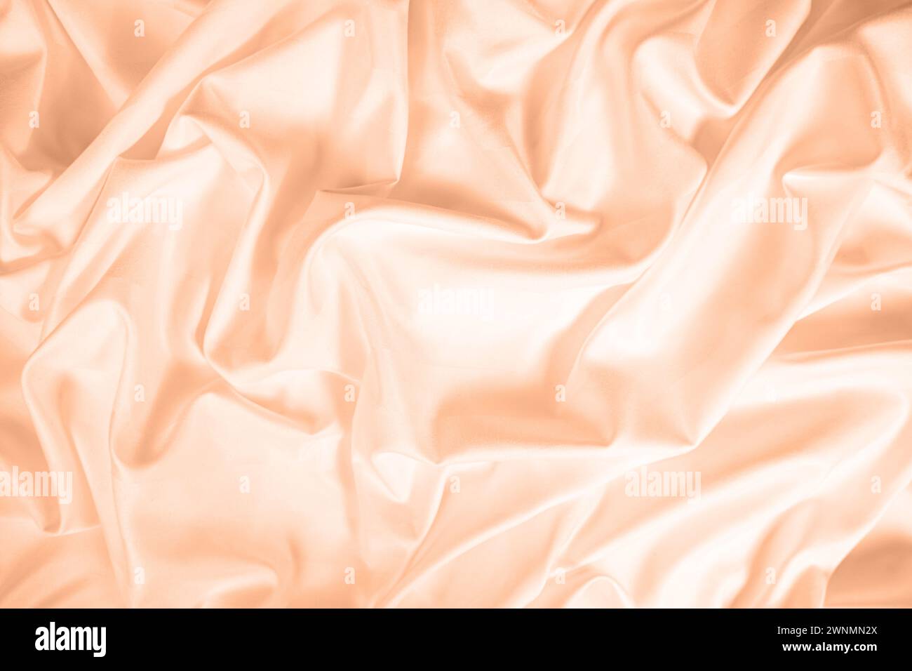 Waves and patterns of crumpled natural satin fabric. Color of the year ...