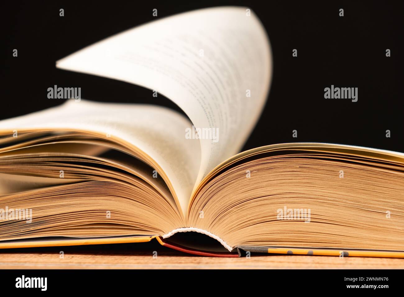 Pages of a thick book are turned on a black background Stock Photo - Alamy