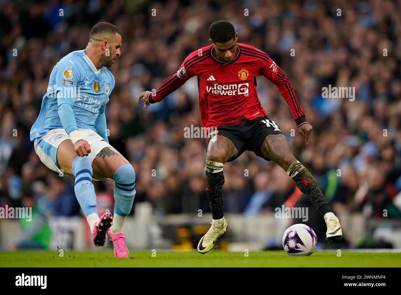 Manchester United's Marcus Rashford, right, controls the ball watched ...