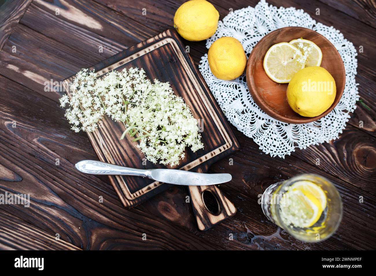 Grinding lemon and black elderberry on a cutting board to make an ...
