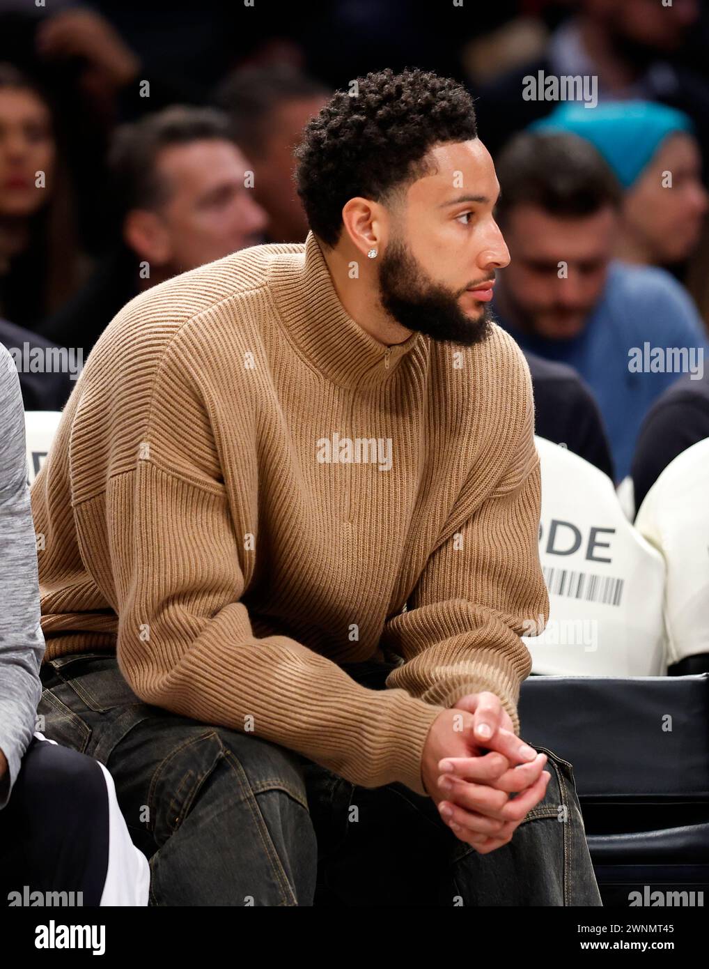 Brooklyn Nets guard Ben Simmons sits on the bench in street clothes ...