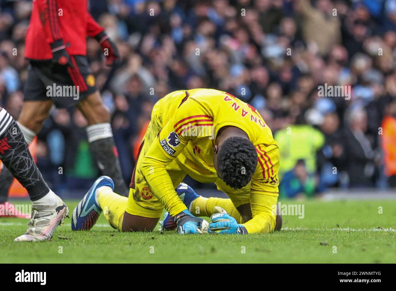 André Onana of Manchester United reacts after rErling Håland of ...