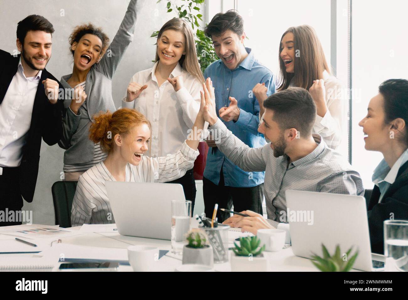 Business team celebrating success together on workplace Stock Photo - Alamy