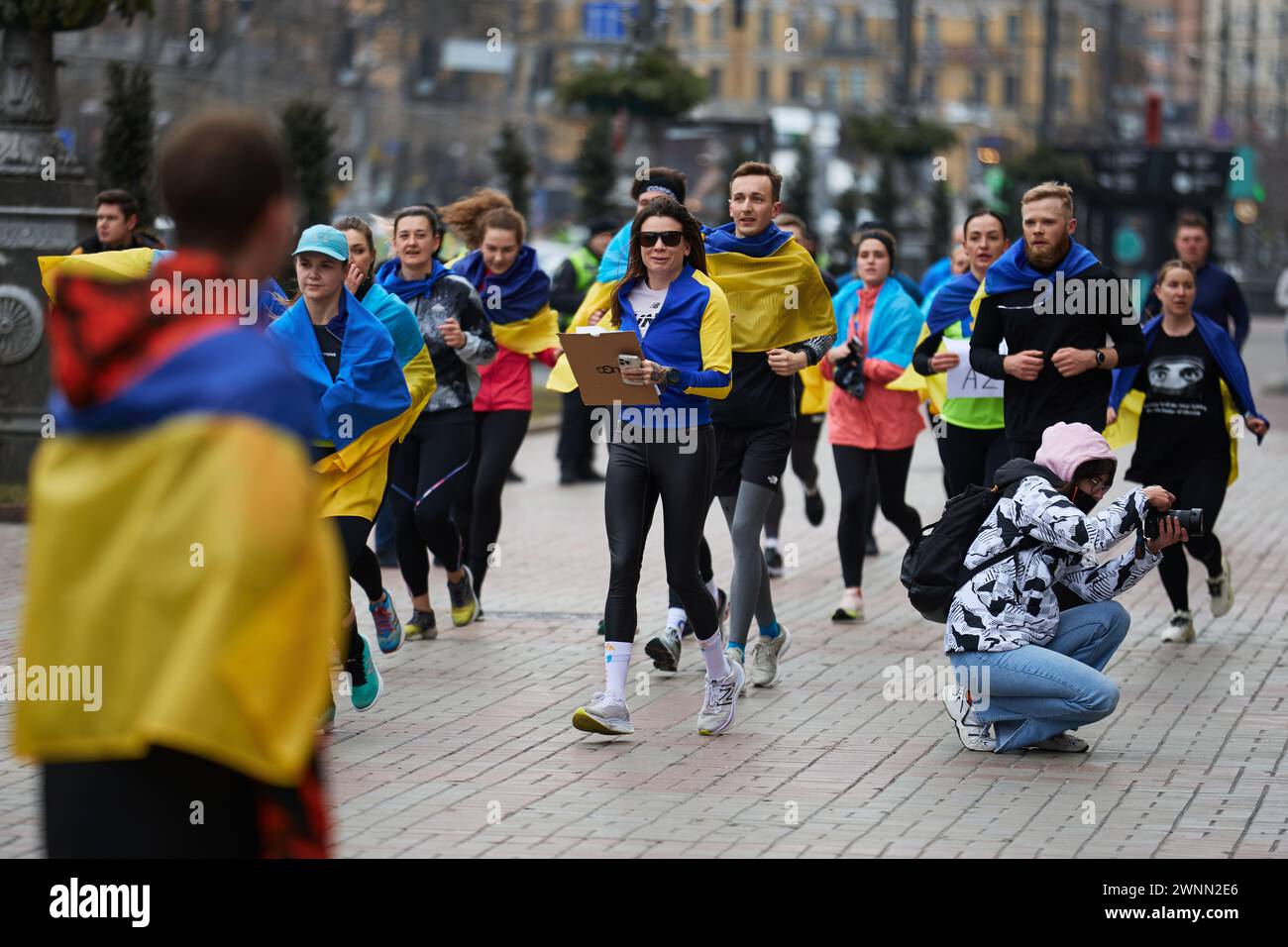 Ukrainian athletes running with national flags on a peaceful rally ...