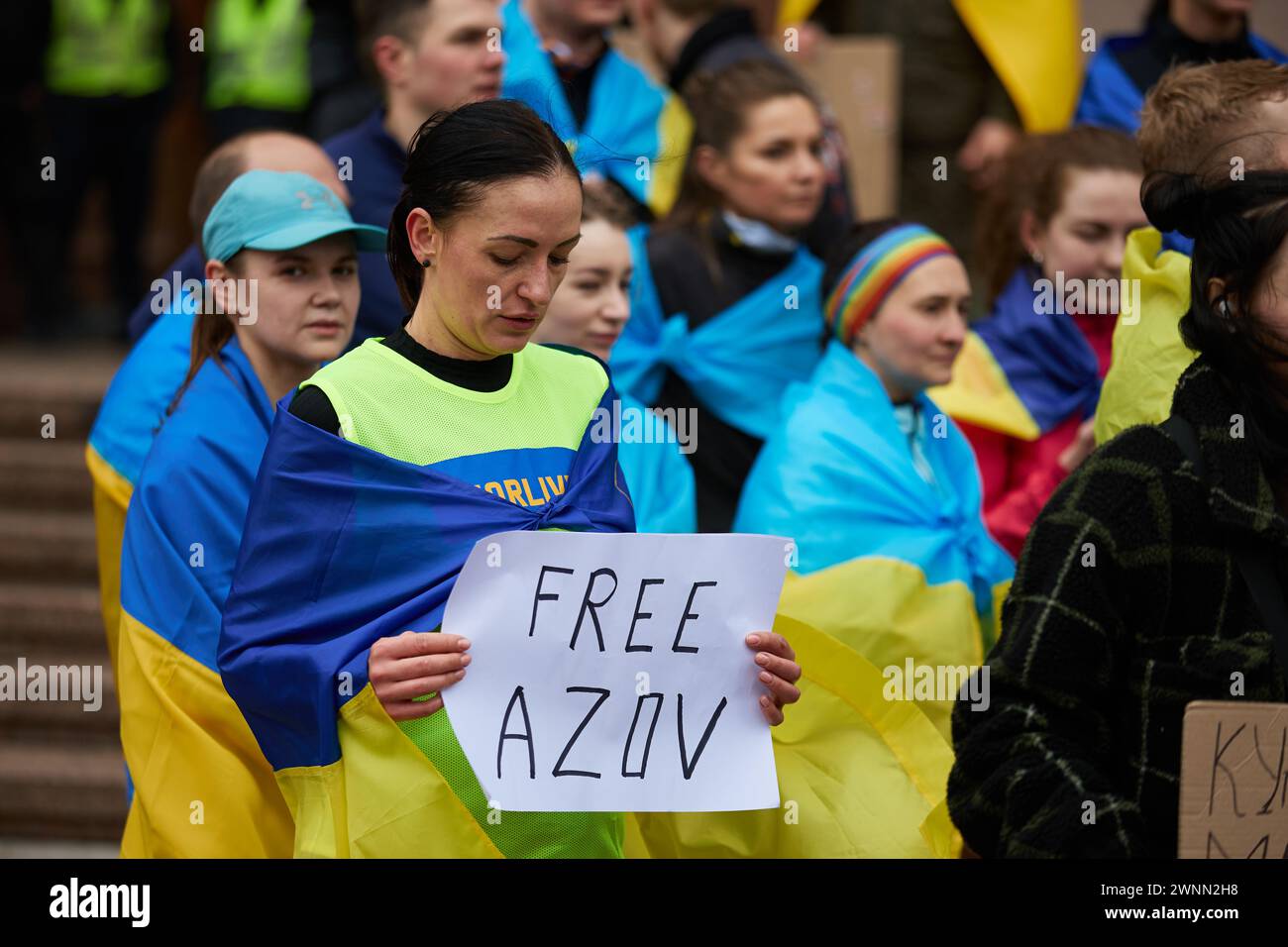 Ukrainain woman holds a banner "Free Azov" on a peaceful demonstration ...