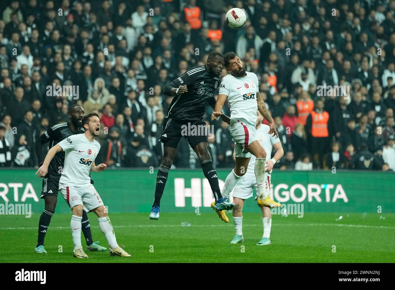 Galatasaray's Kerem Demirbay, right, goes for a header with Besiktas ...