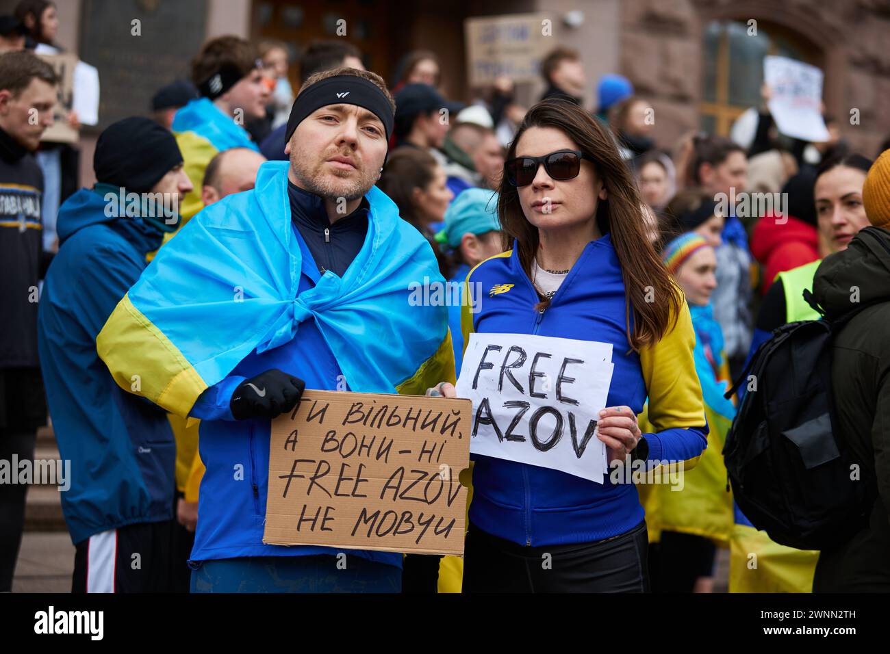 Ukrainian athletes posing with banners "Free Azov" on a rally. Public ...