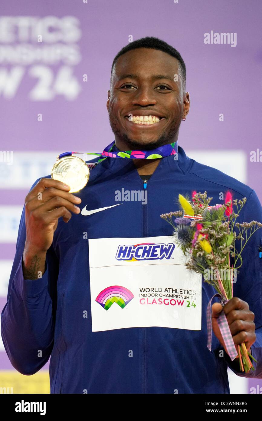 Grant Holloway, of the United States, poses on the podium after winning ...