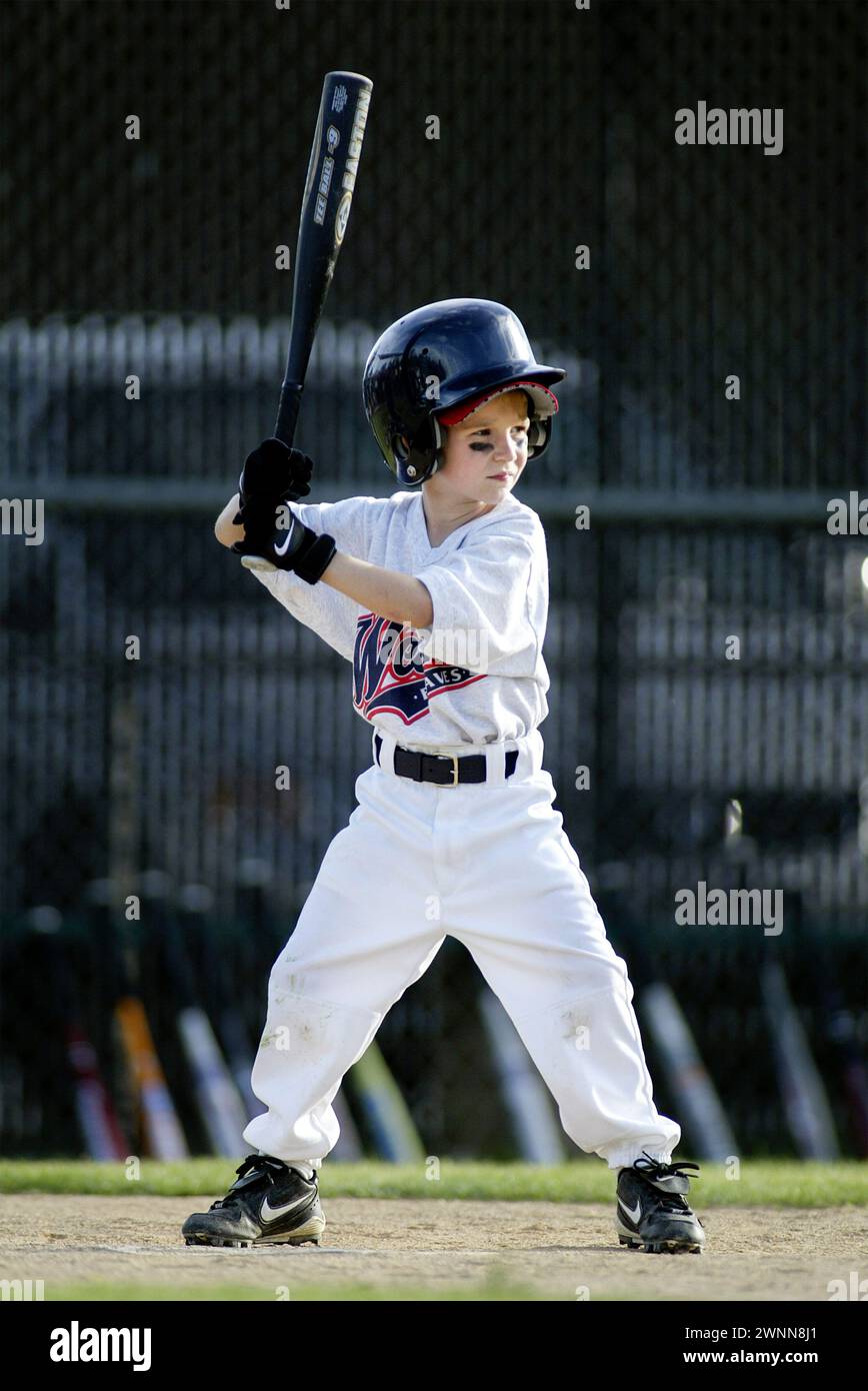 Boy hitting ball with baseball bat hi-res stock photography and images ...