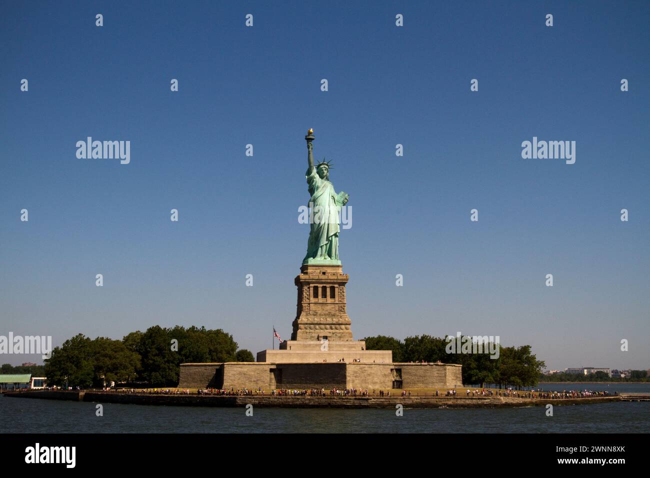 The Statue of Liberty stands tall as visitors take a boat tour of the ...