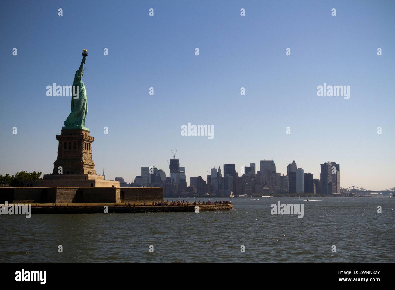The Statue of Liberty stands tall as visitors take a boat tour of the ...