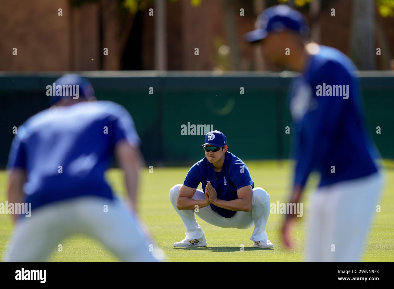 Los Angeles Dodgers' Shohei Ohtani stretches during spring training ...