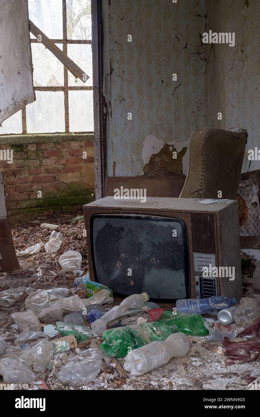 discarded dumped television amongst empty plastic bottles inside ...