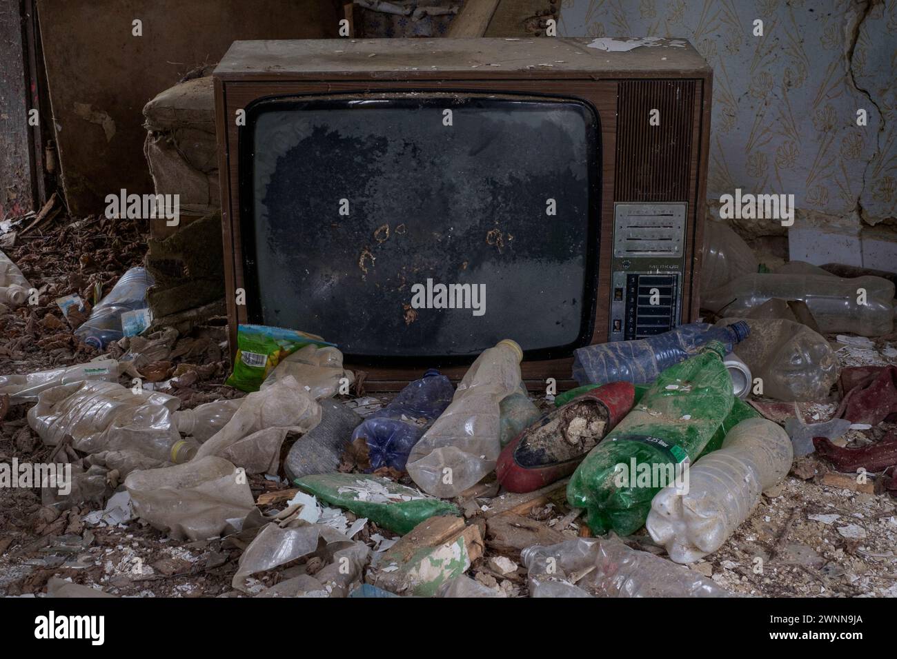 discarded dumped television amongst empty plastic bottles inside ...