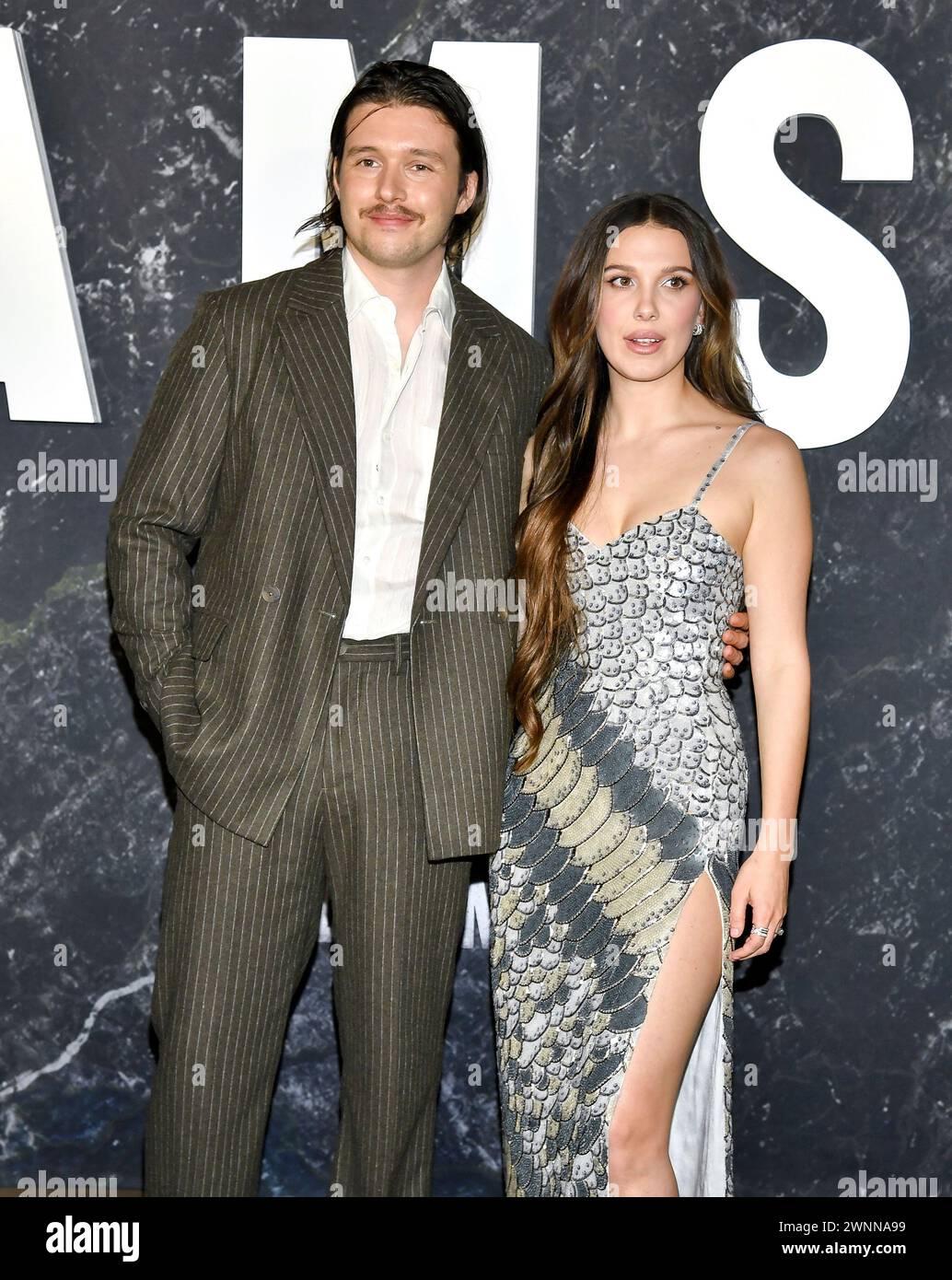 Nick Robinson, left, and Millie Bobby Brown attend the premiere of ...