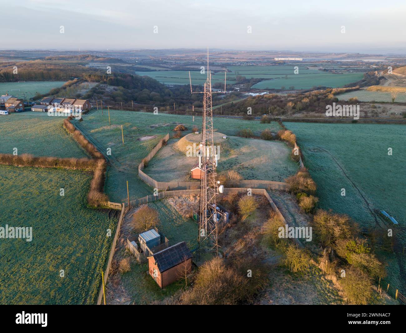 Drone image of a lone telecom tower with surrounding green fields under ...