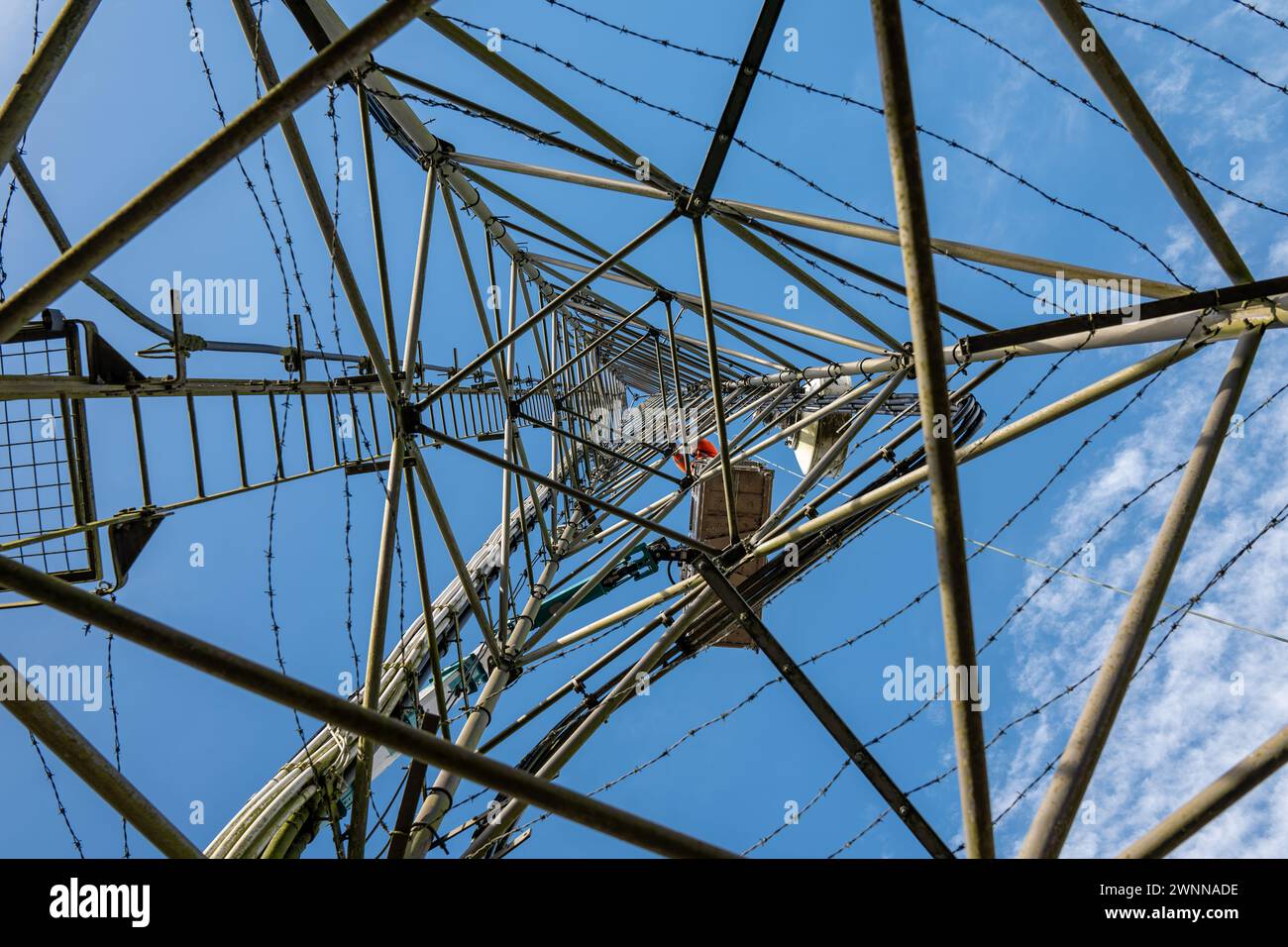 Abstract view of a towering radar structure with intricate metalwork ...