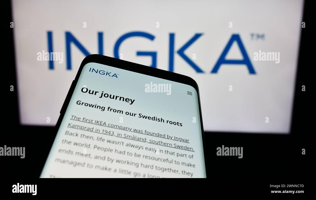 Mobile phone with webpage of Dutch company INGKA Holding B.V. in front of business logo. Focus ...