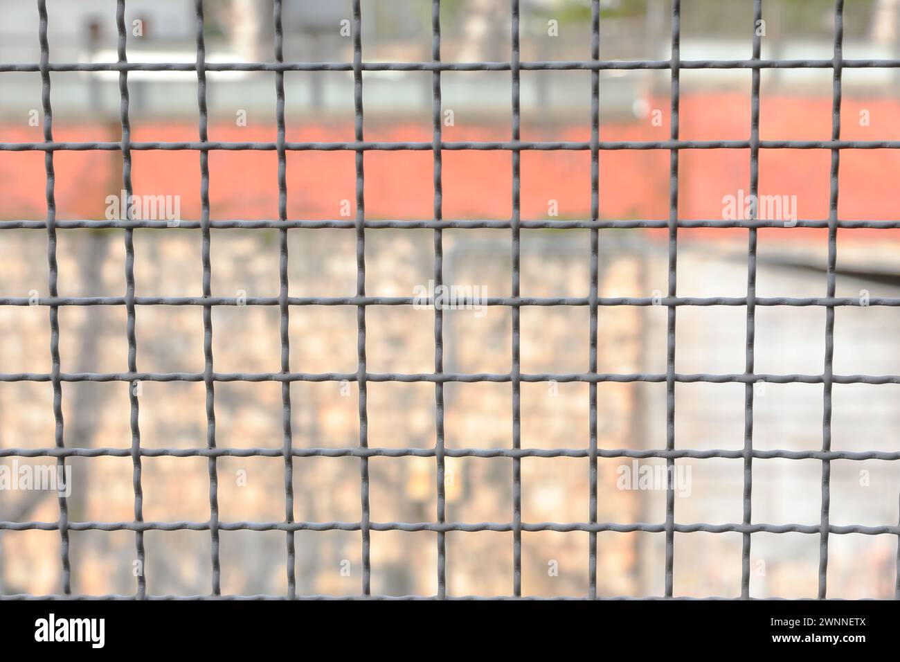 metal border separation mesh and the building wall intentionally ...