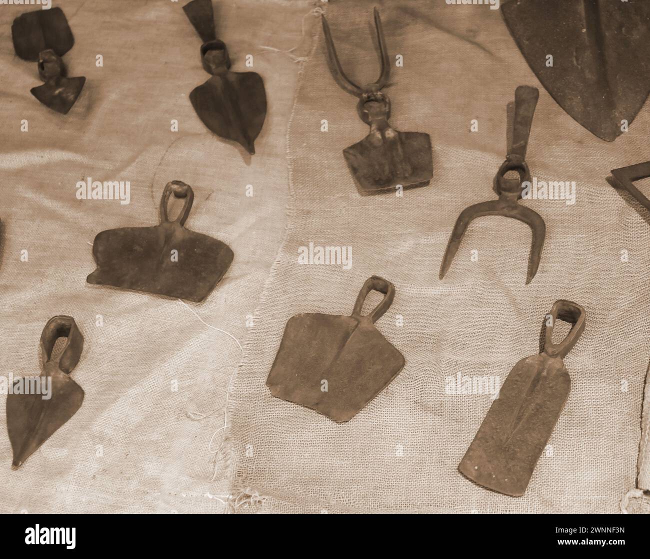 old rusty agricultural tools used long ago by farmers with sepia ...