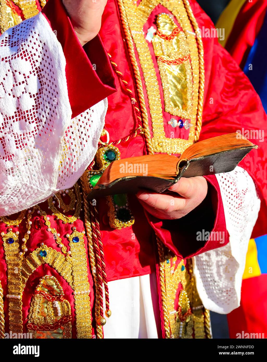 bible with the sacred scriptures in the bishop's hand with a ring with ...