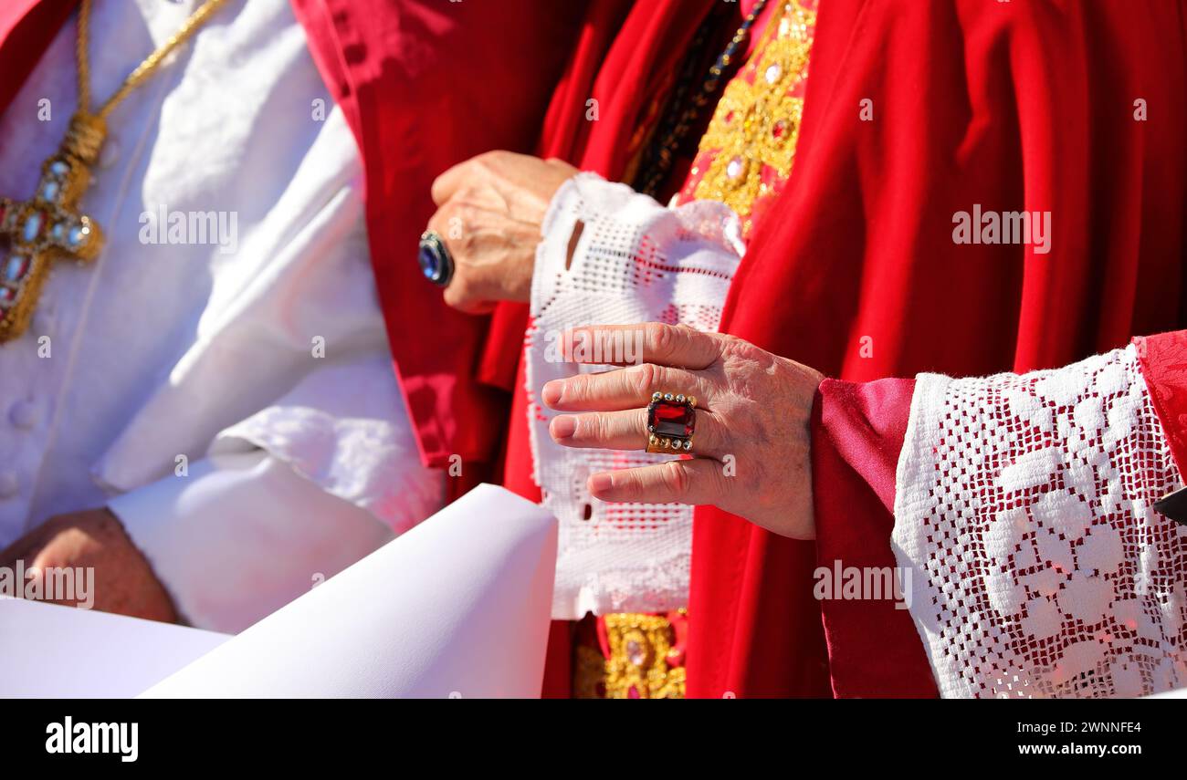 hand of a bishop in clerical dress blessing the faithful during a ...